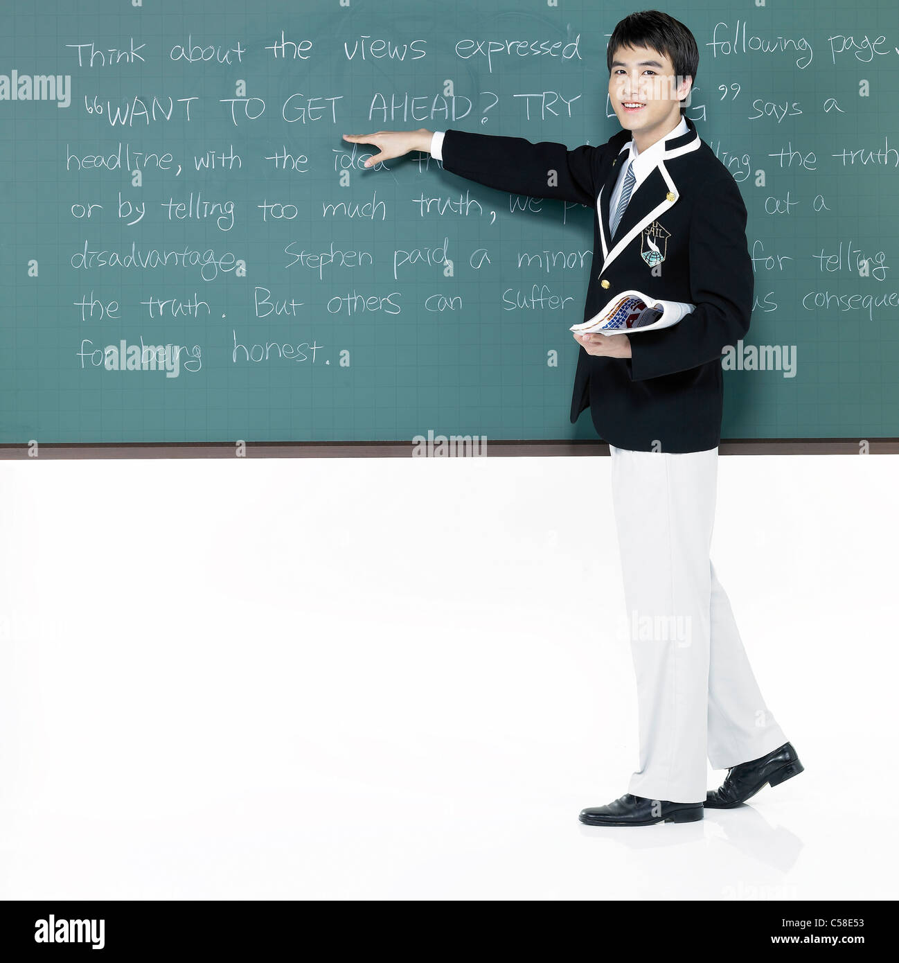 Portrait of teenage boy pointing on blackboard Stock Photo - Alamy