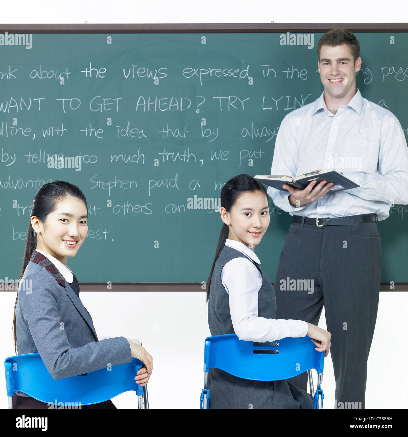 Portrait of teacher and student sitting in classroom Stock Photo - Alamy