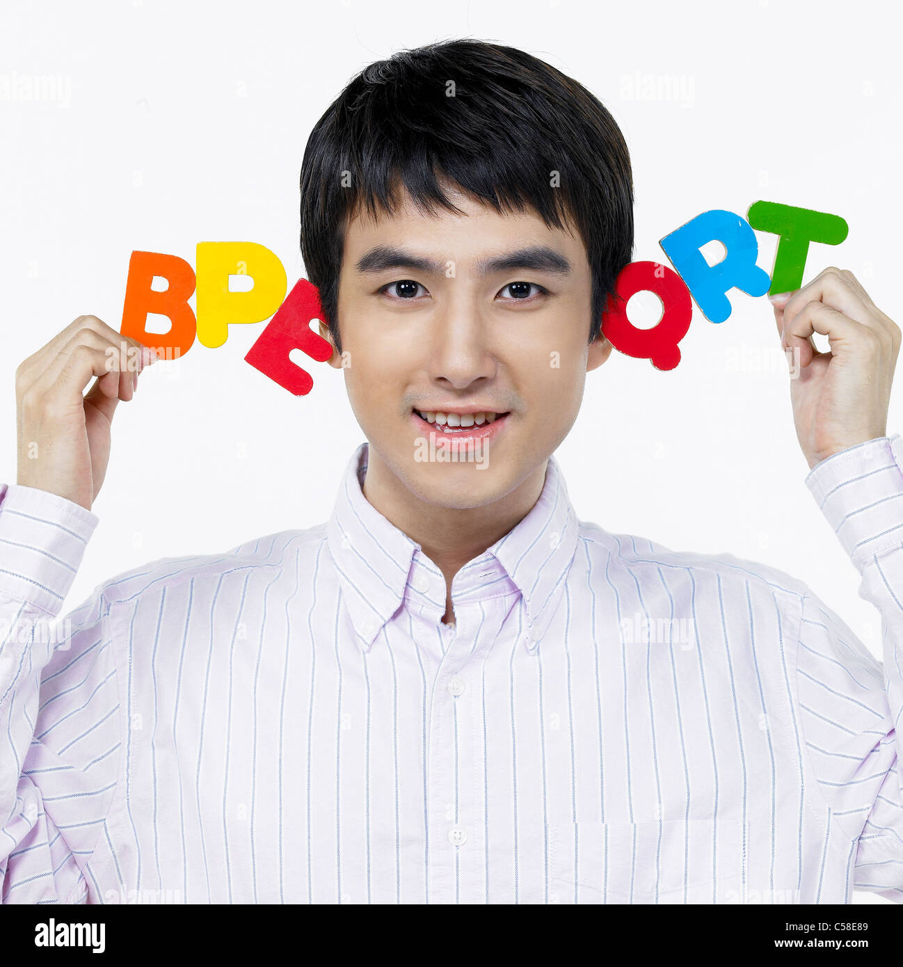 Portrait of teenage boy holding alphabet Stock Photo - Alamy