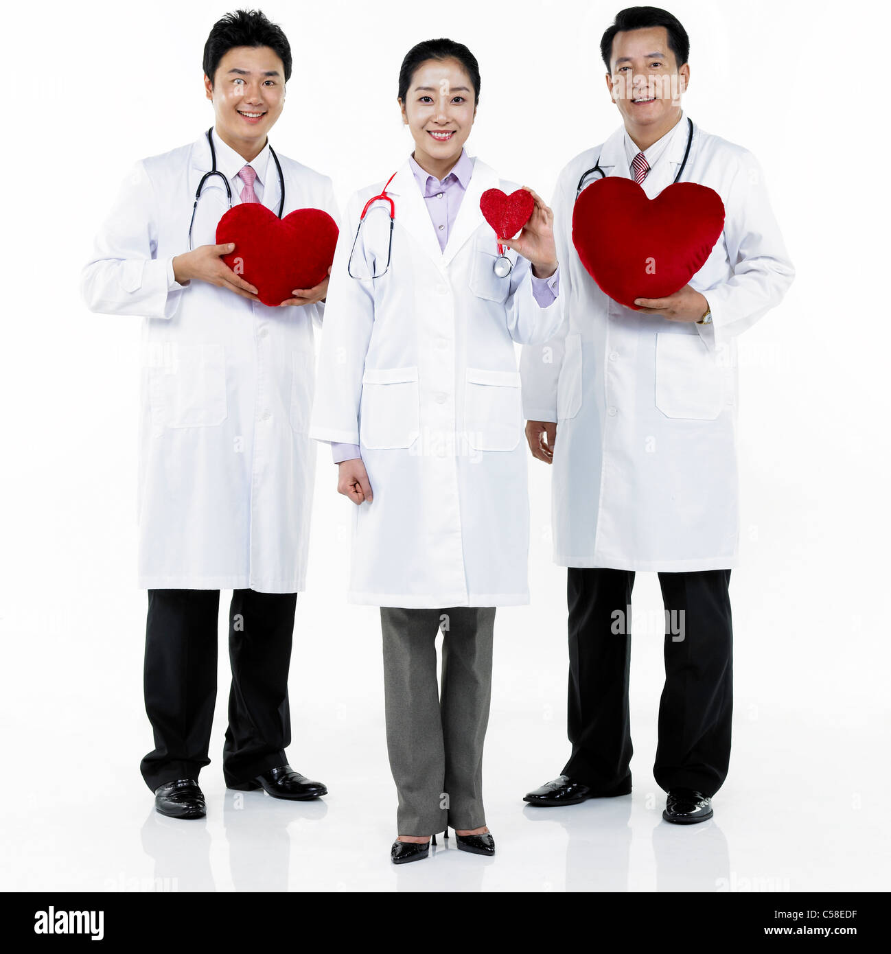 Portrait of doctors holding heart shape, smiling Stock Photo - Alamy