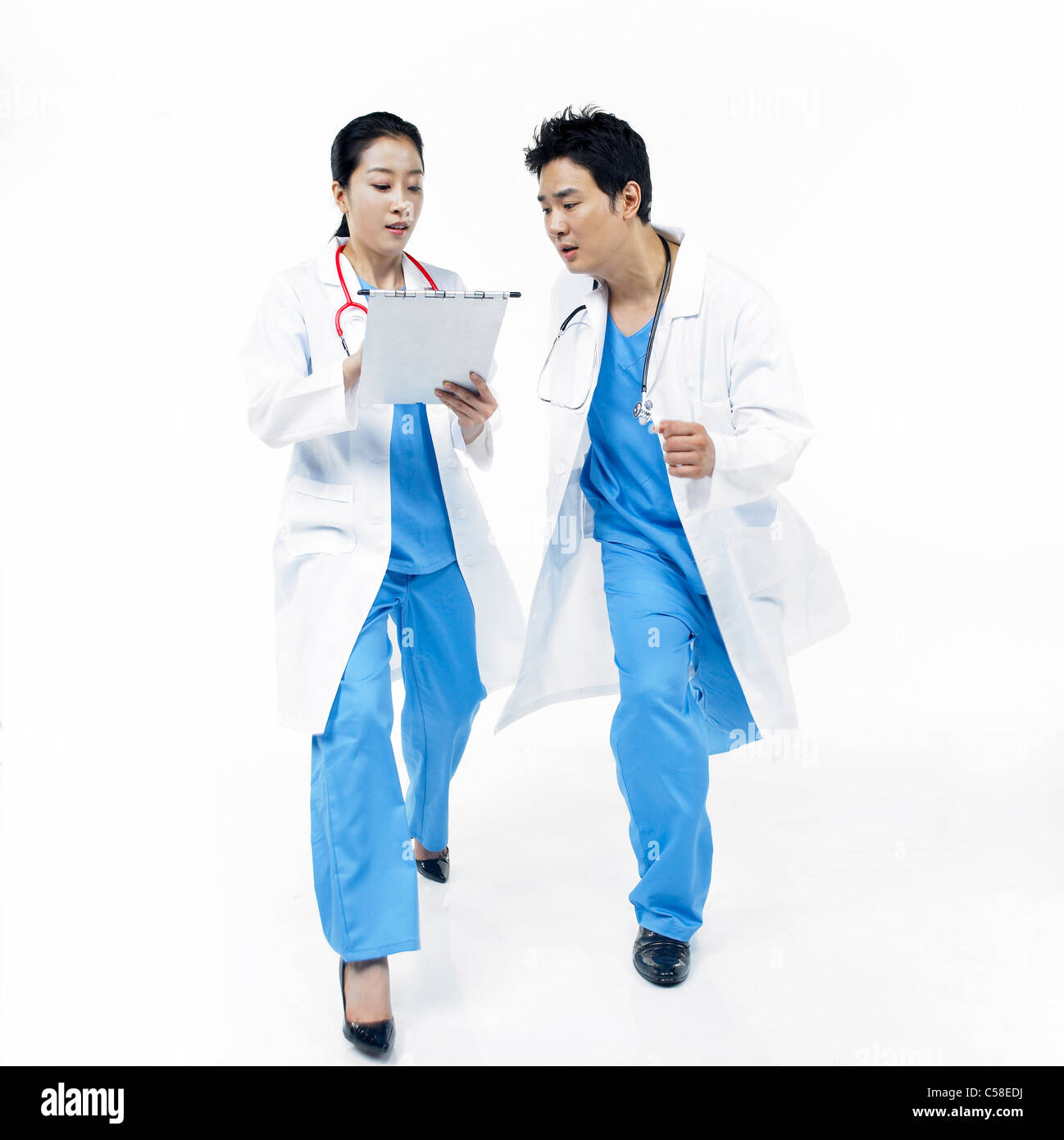 Doctors reading medical chart, running Stock Photo - Alamy