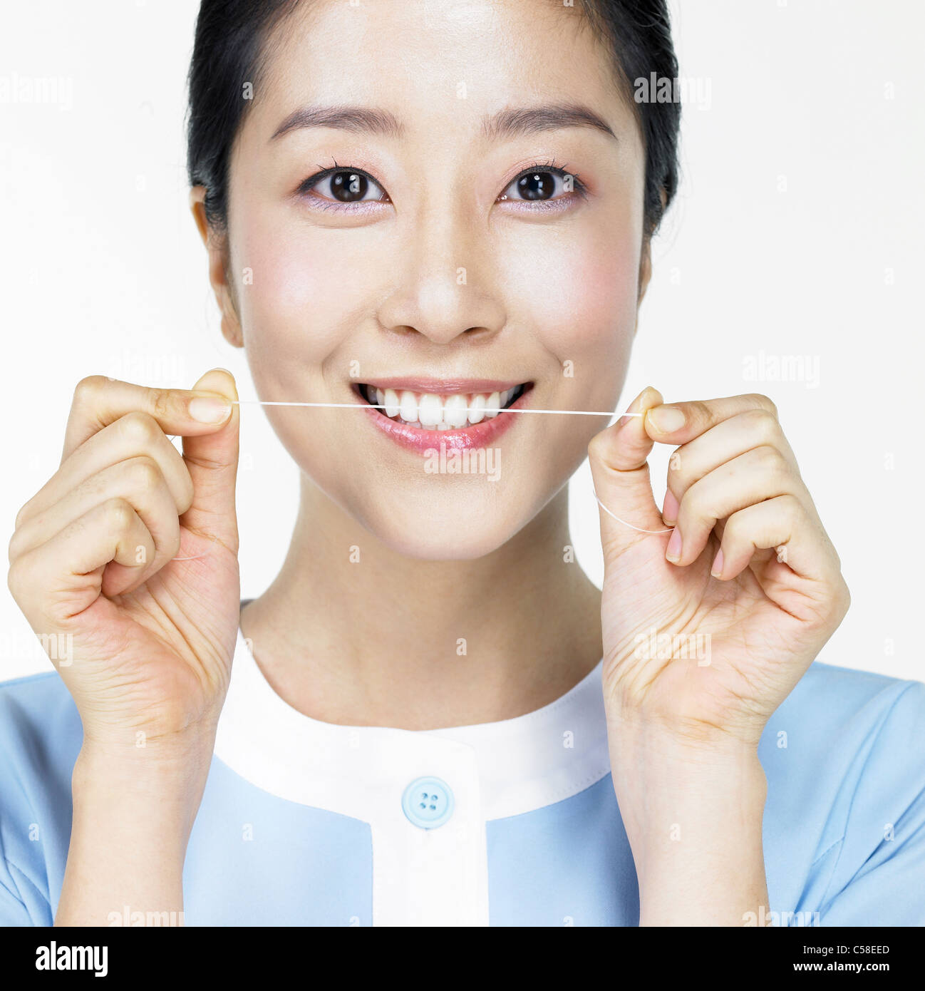 Portrait of woman cleaning teeth with dental floss Stock Photo - Alamy
