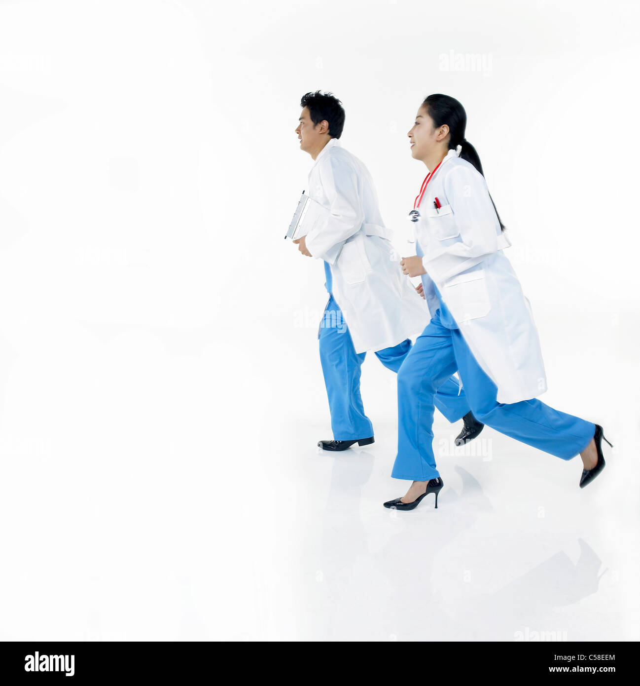 Side view of Doctors Holding medical chart, running Stock Photo - Alamy