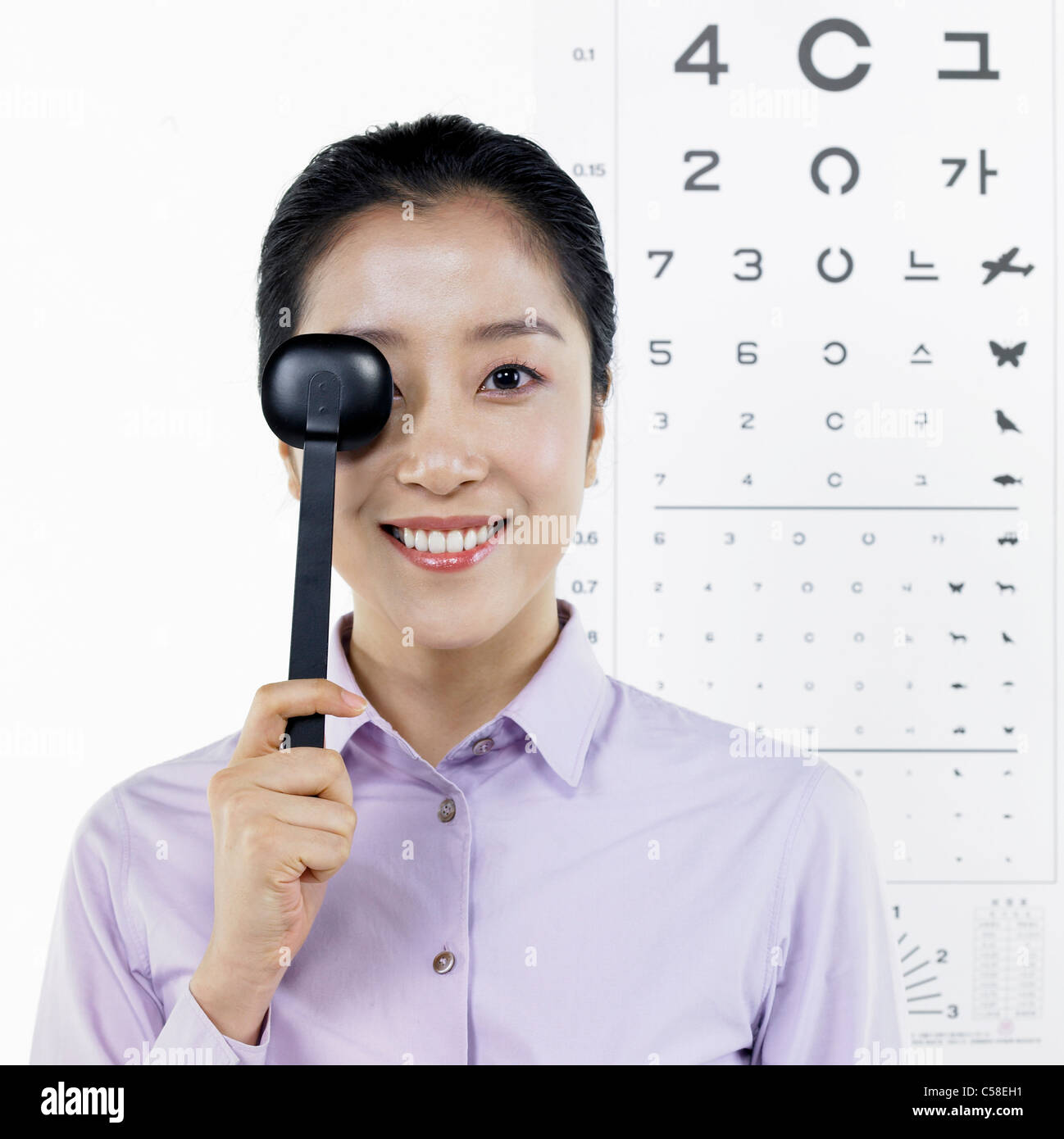 Portrait of Eye doctor standing by eye chart Stock Photo - Alamy