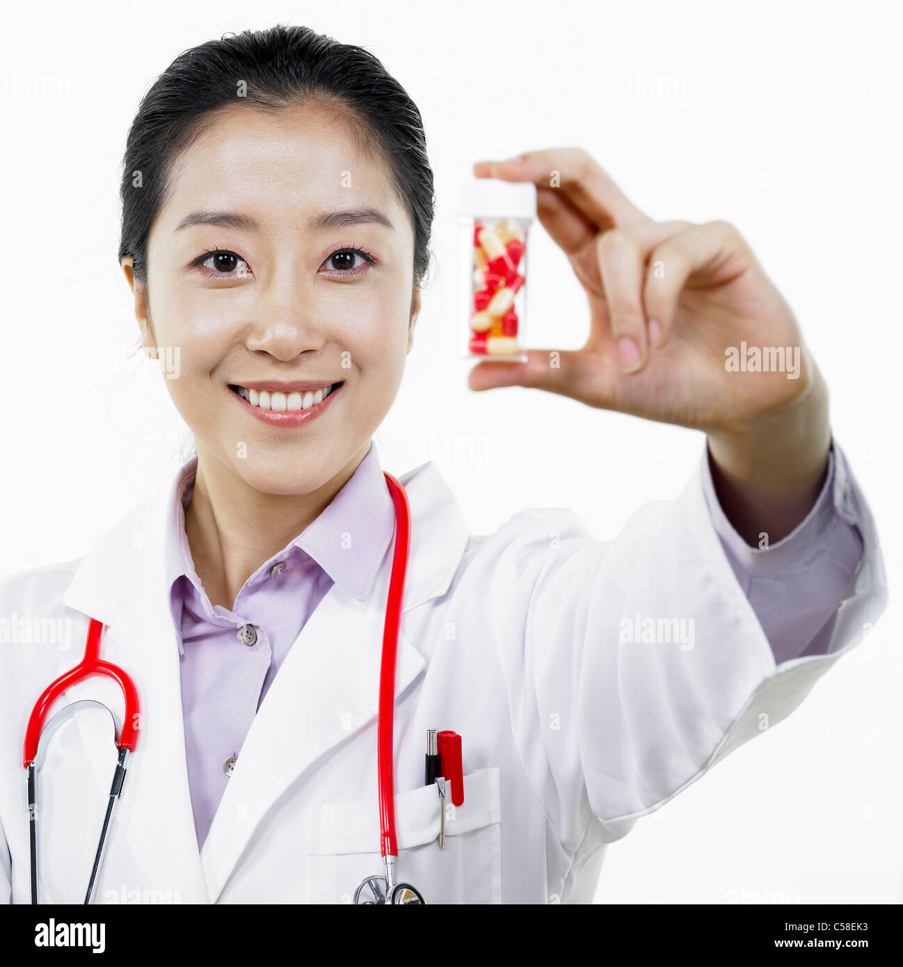 Young doctor holding pill container hi-res stock photography and images ...