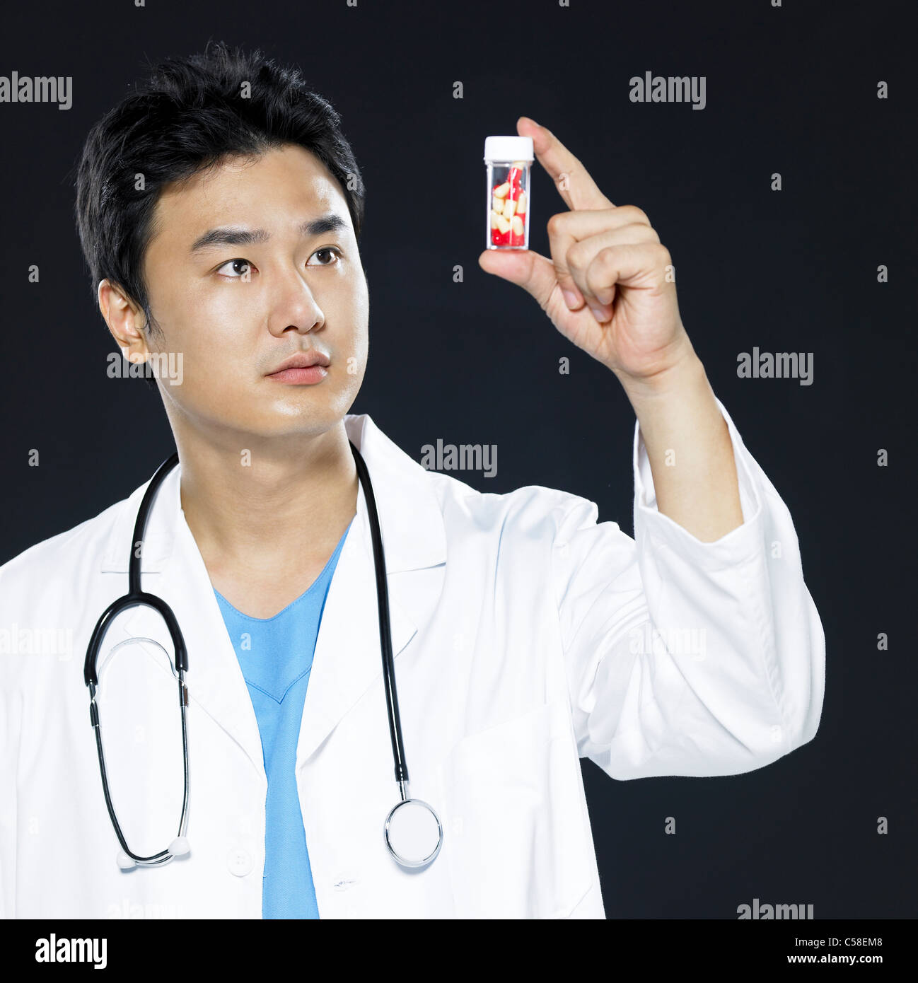 Male doctor holding Up Bottle of Pills Stock Photo - Alamy