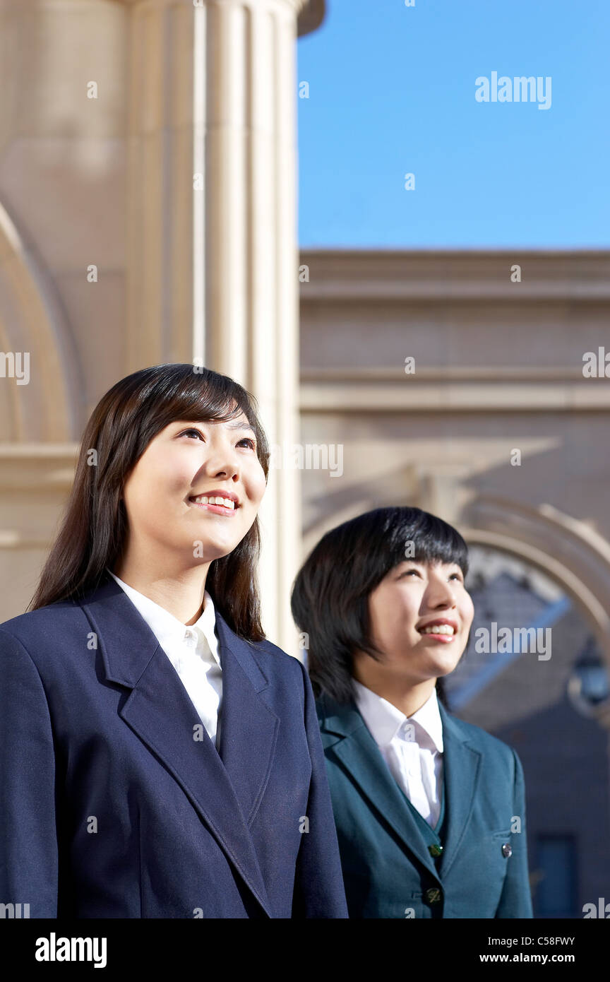 Side view of teens standing on steps in college Stock Photo - Alamy