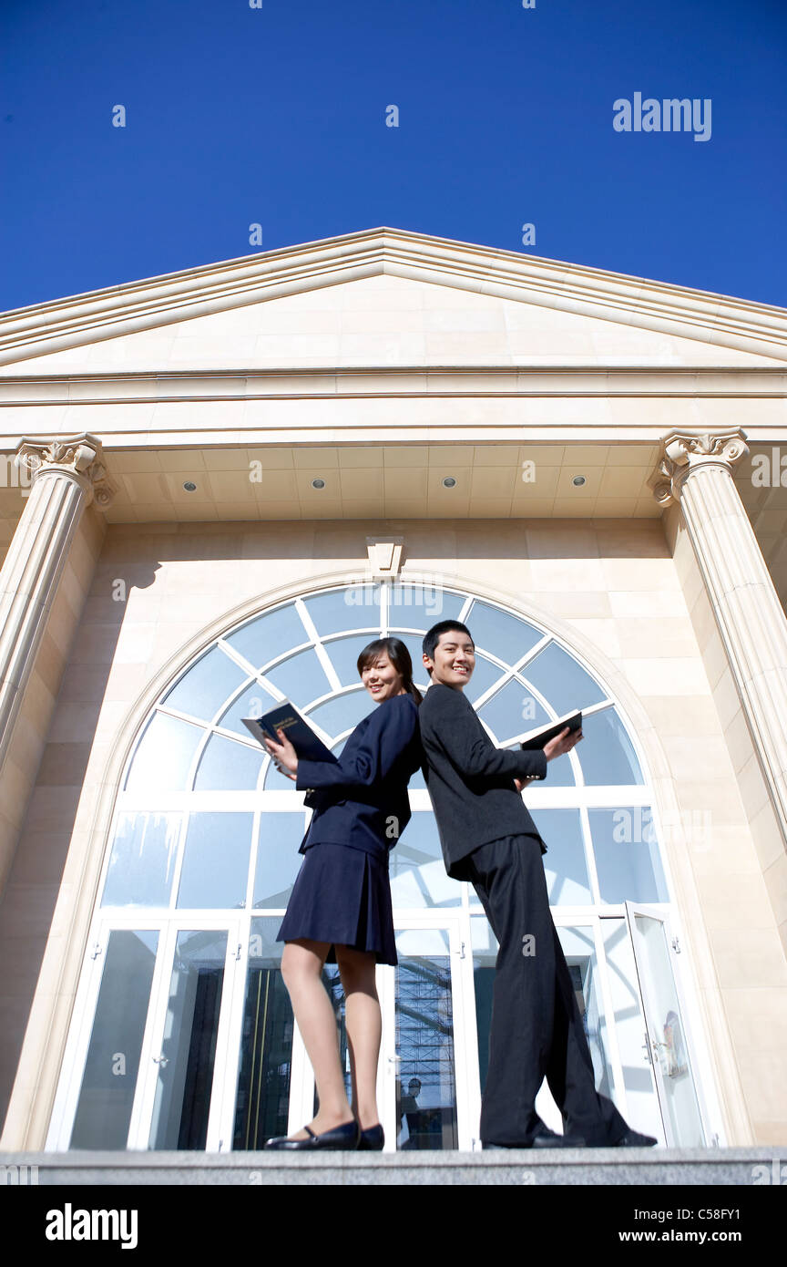 Portrait of young standing with college in background Stock Photo - Alamy