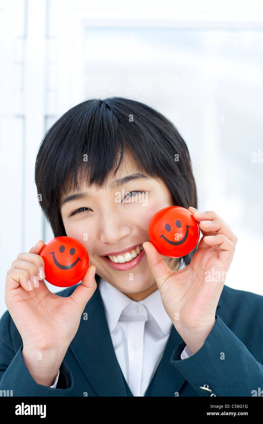 Close-up of teenage girl holding smiley face Stock Photo - Alamy