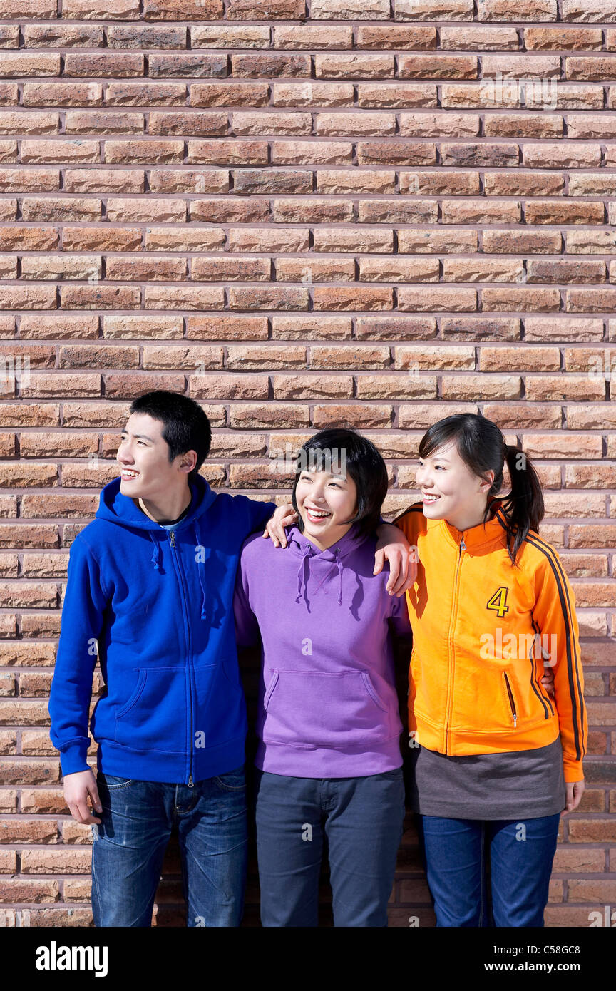 Teens standing by wall Stock Photo - Alamy