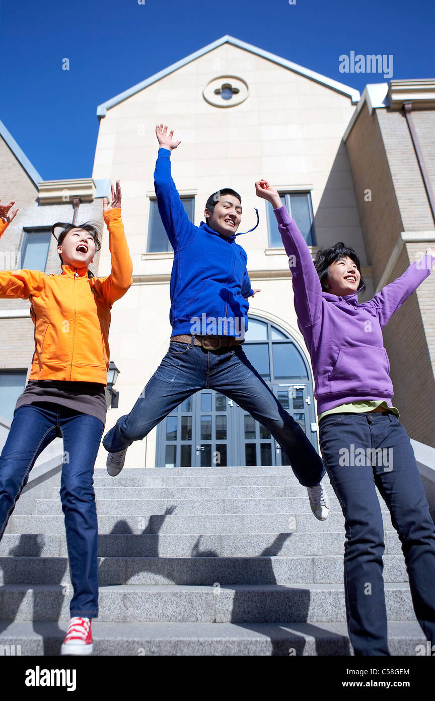 Boy and girl jumping on steps Stock Photo - Alamy