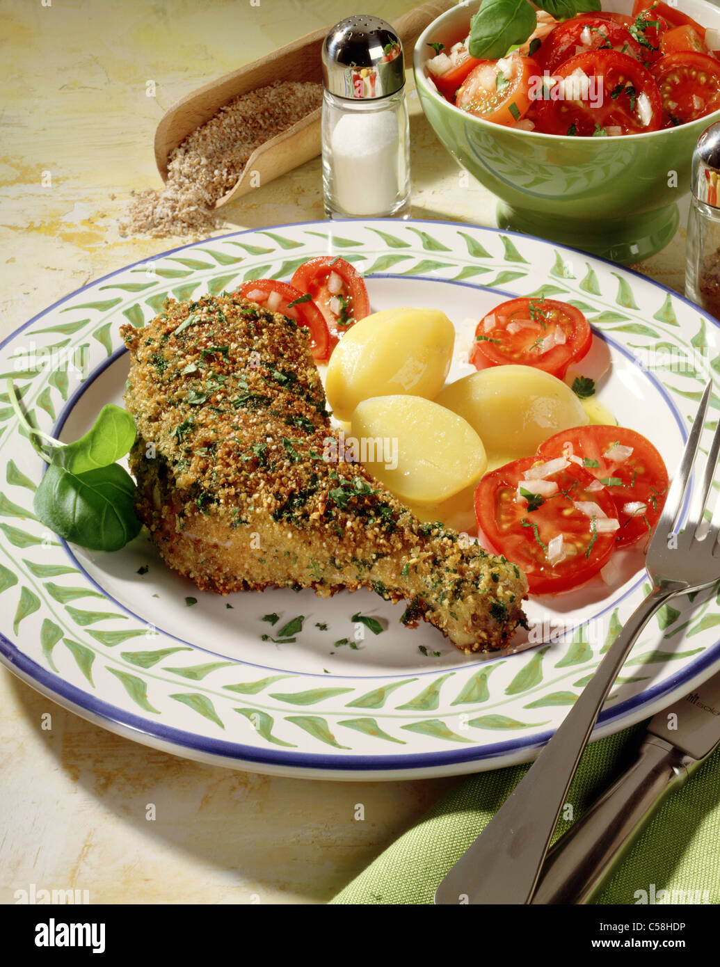 Haunch of chicken coated with spicy herb breadcrumbs Stock Photo - Alamy