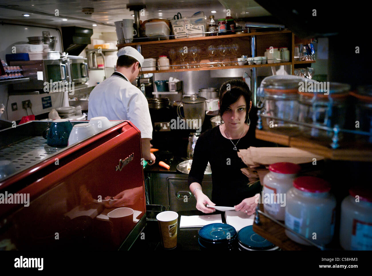 A waitress and chef at work in a cafe in Sandymount, Dublin Ireland on ...