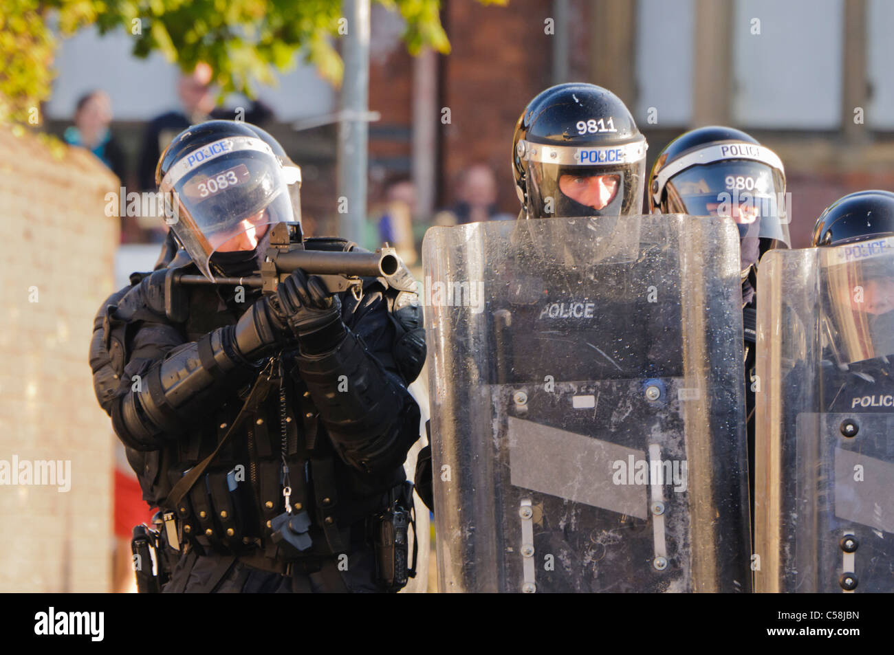 Police officer aims a Heckler and Koch L104A1 37mm single-shot AEP ...