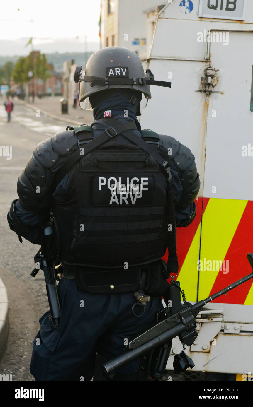 Police officer in riot gear with a Heckler and Koch L104A1 37mm single ...