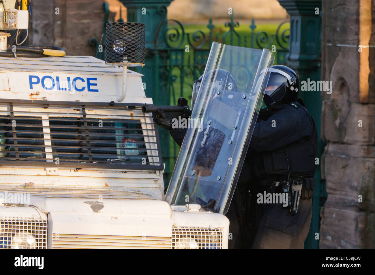 Police officer aims a Heckler and Koch L104A1 37mm single-shot AEP ...