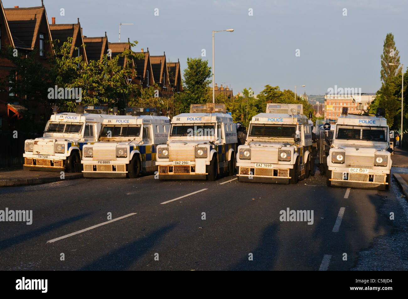 Line of Police landrovers Stock Photo - Alamy