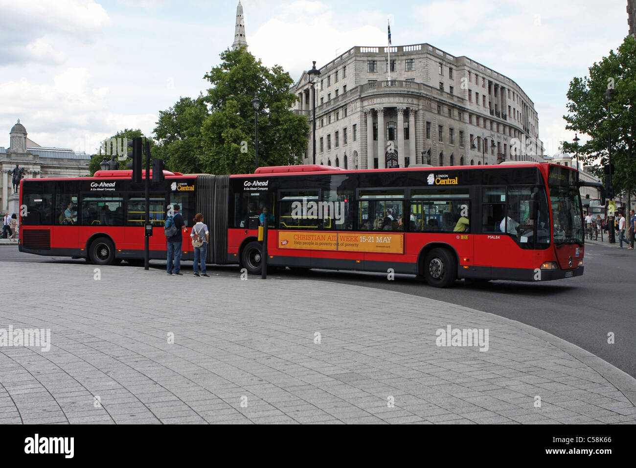 A bendy bus traveling around Trafalgar Square in London Stock Photo - Alamy