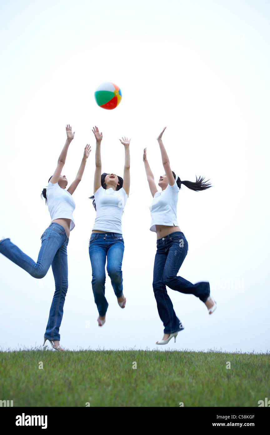 Young women catching ball Stock Photo - Alamy