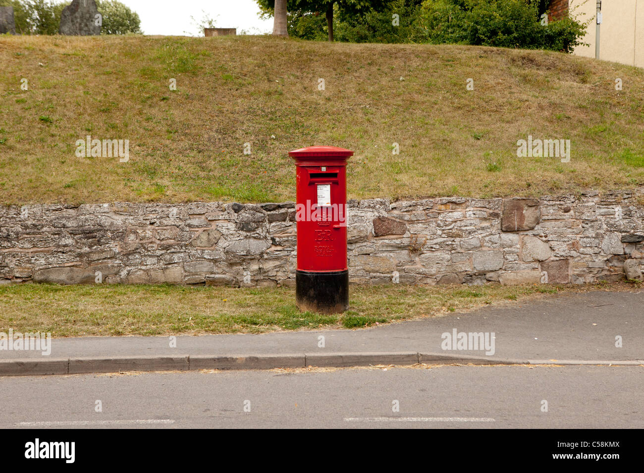 A red UK cast-iron Royal Mail freestanding Pillar Box with an EiiR ...