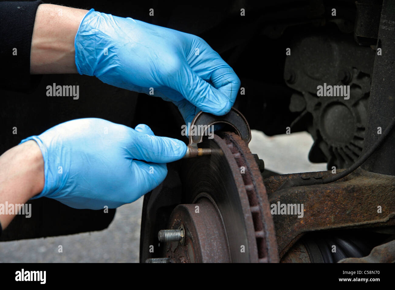 Technician Measuring a brake disc for wear using a micrometer Stock ...