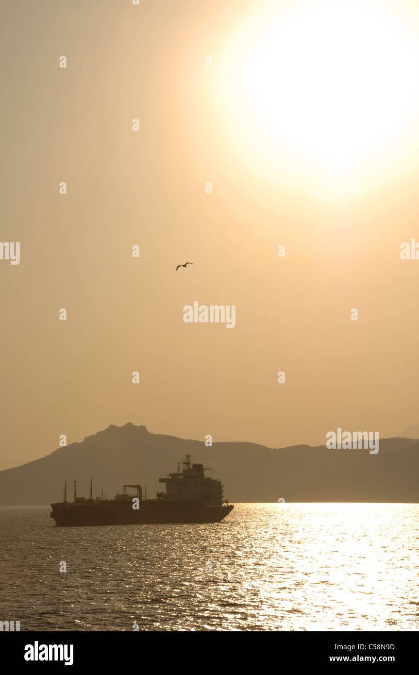 Merchant vessel at sunset. Saronic Gulf. Greece Stock Photo - Alamy
