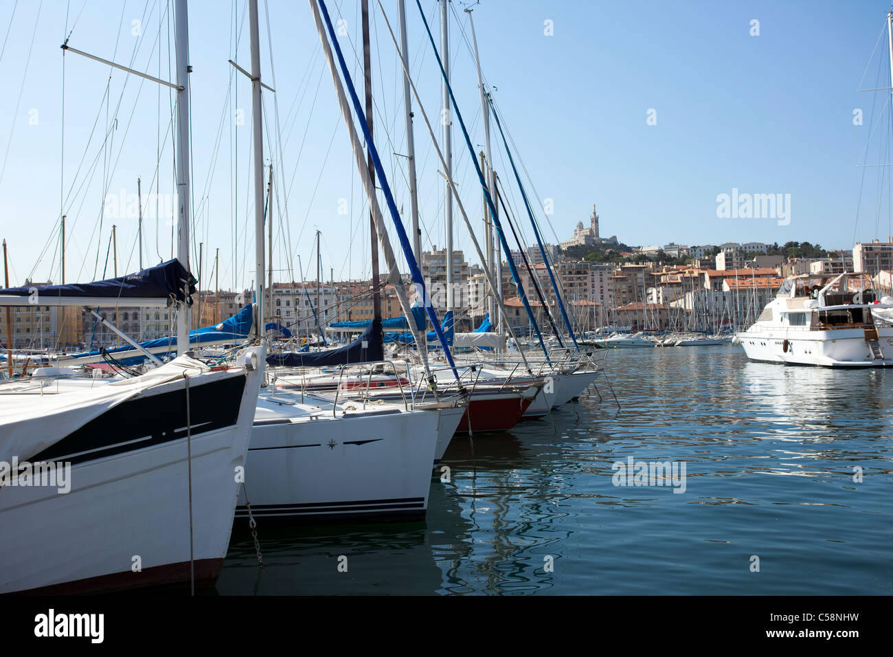 Marseille France marina with sailboats, cruise boats with Basilica ...