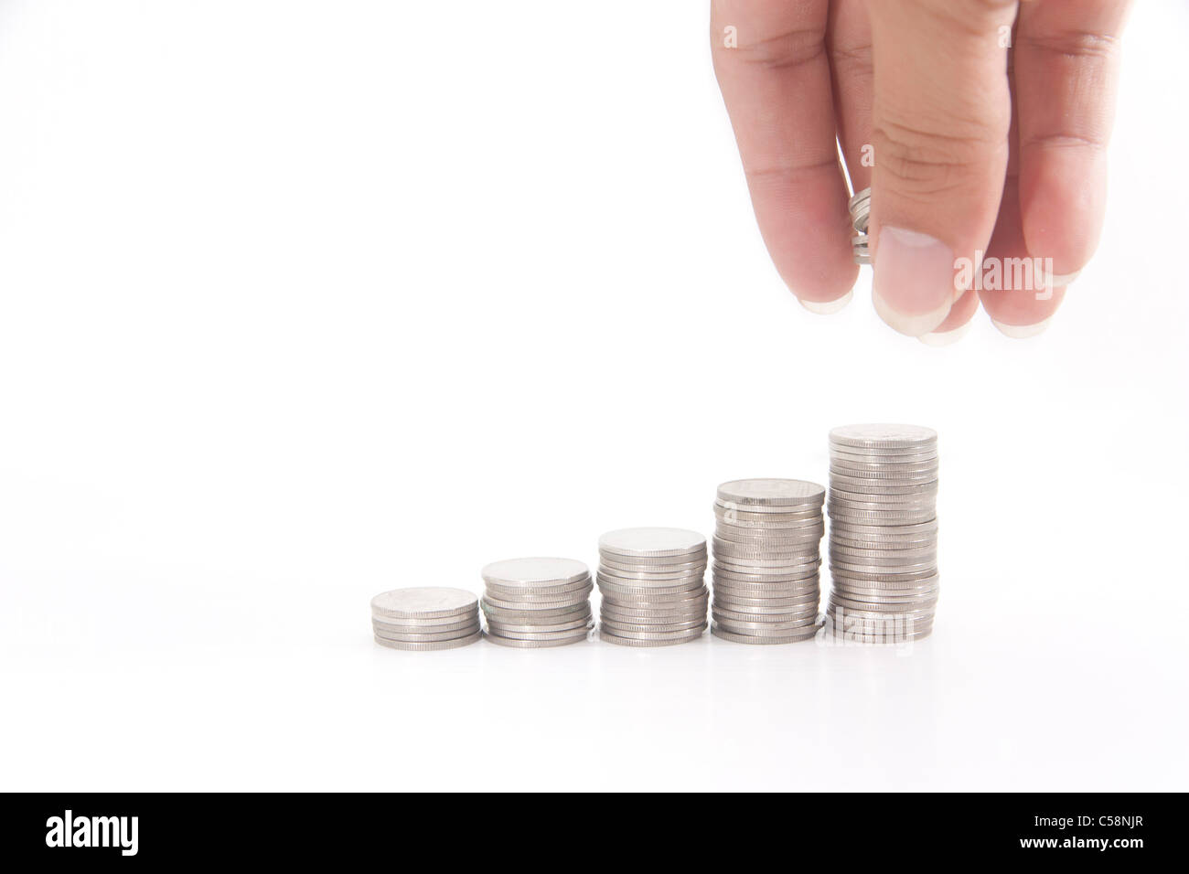 Stack money and a hand in action on white isolate Stock Photo - Alamy