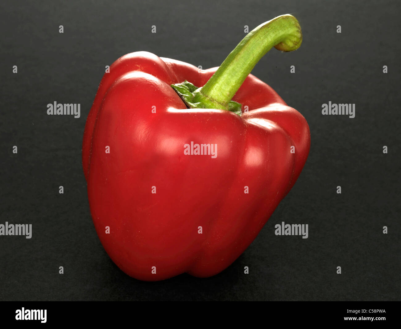 Single Whole Ripe Red Pepper Against A Black Background With No People ...