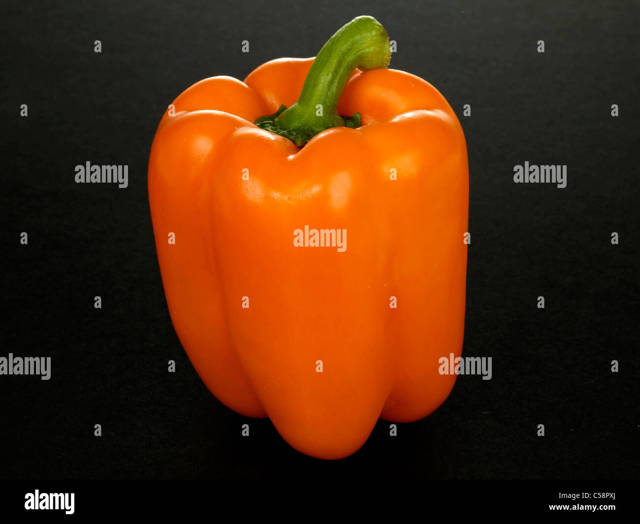 Whole Fresh Single Uncooked Raw Orange Pepper Against A Black ...