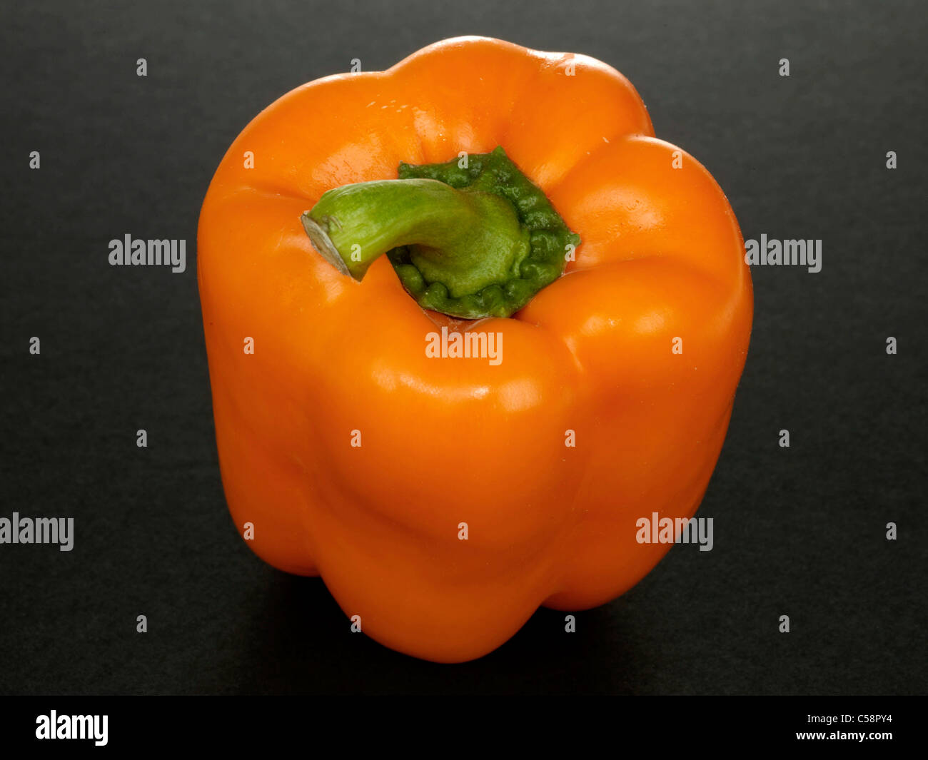 Whole Fresh Single Uncooked Raw Orange Pepper Against A Black ...