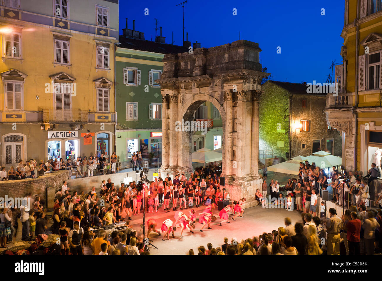 An evening performance taking place beneath the "Golden Gate" of Pula ...