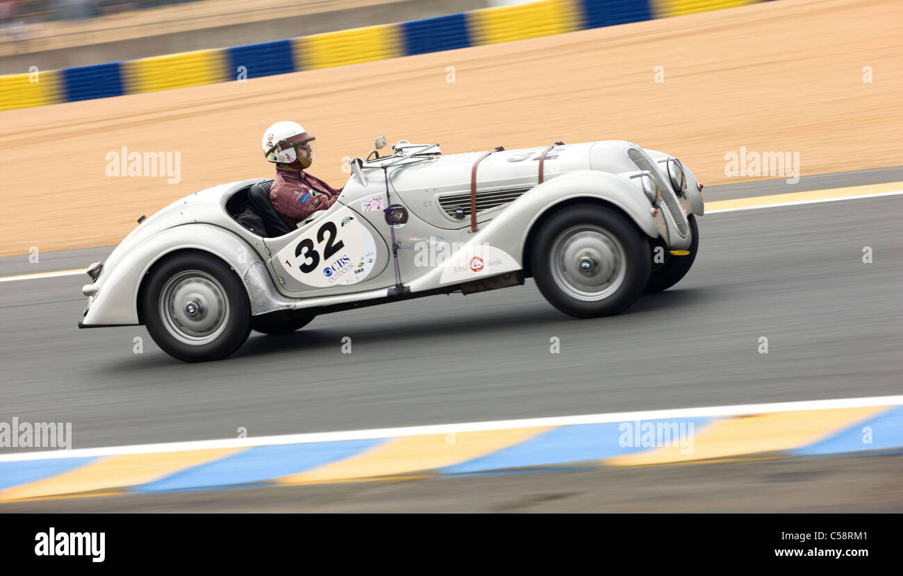 An old classic car races round the track. Le Mans Classic Car Race ...