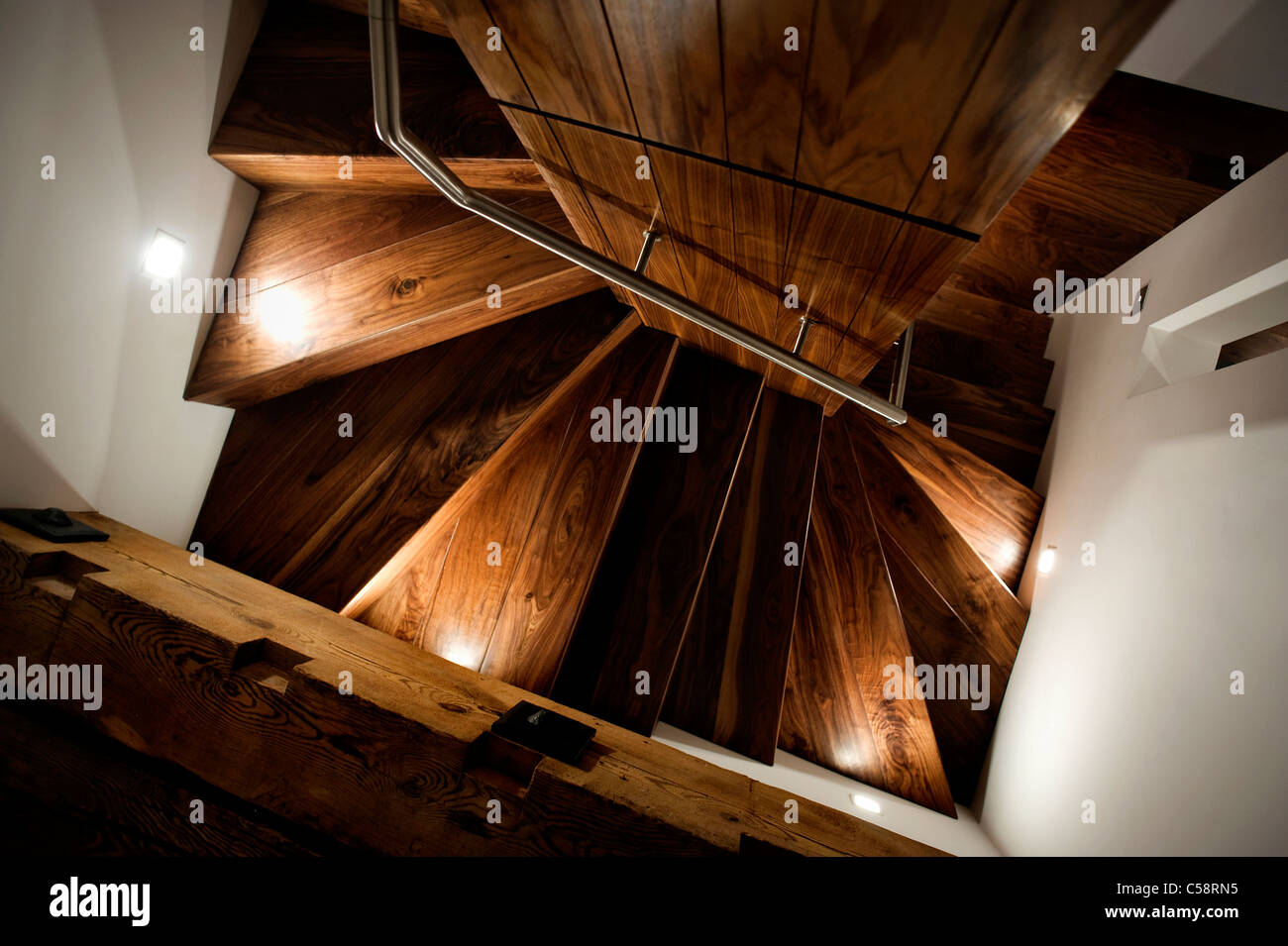 Interior of a wooden staircase with spotlights and white walls from ...