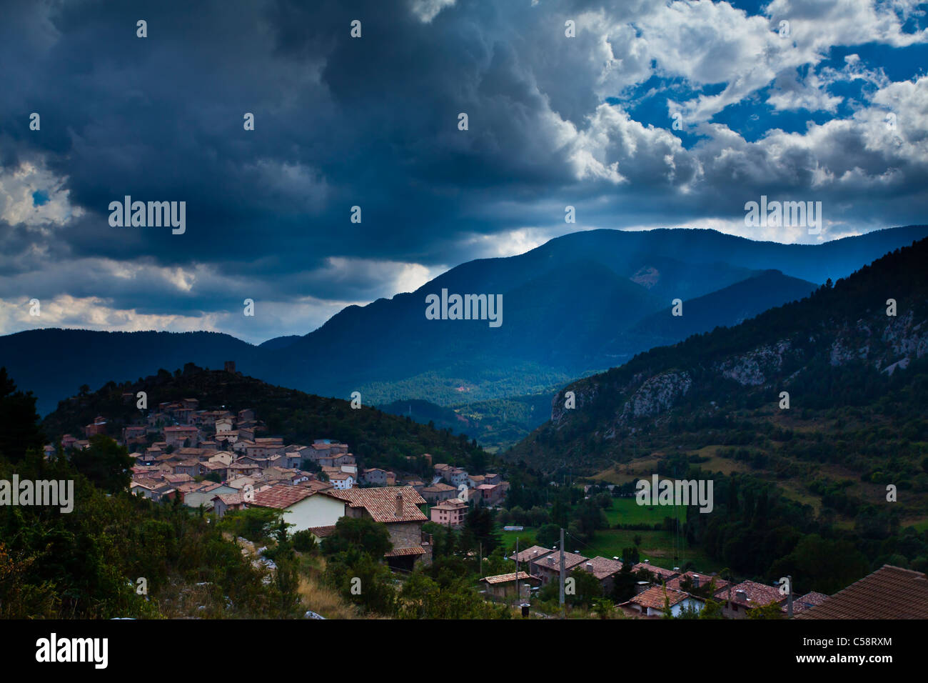 Spain, Catalonia, Pyrenees, Gósol. A storm brews above the village of ...