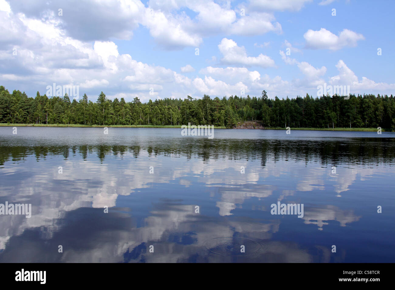 Blue lake reflections in Finland Stock Photo - Alamy