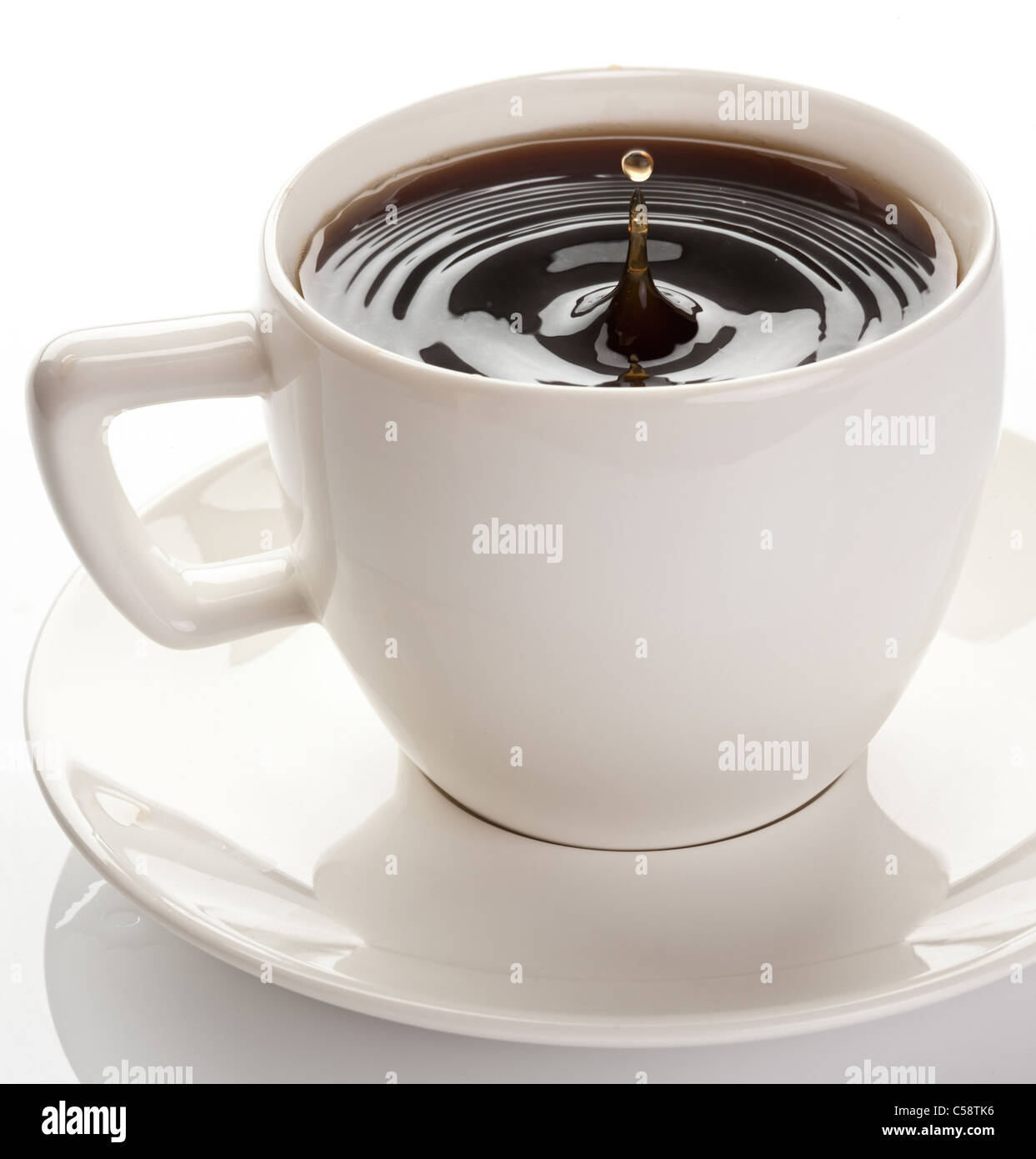 Splash in coffee cup. Isolated on a white background Stock Photo - Alamy