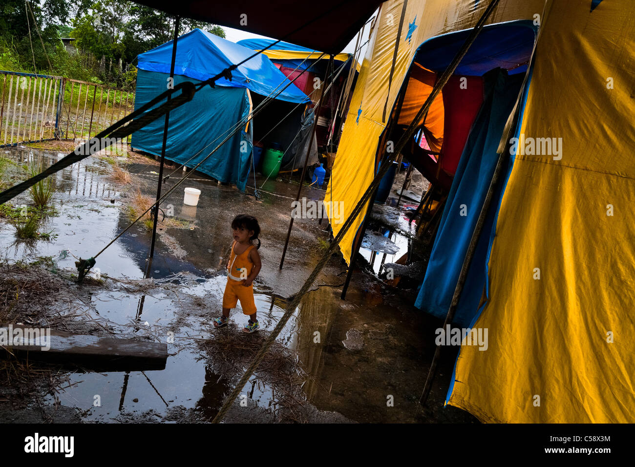 A little Colombian girl walks through puddle at the Circo Anny, a ...
