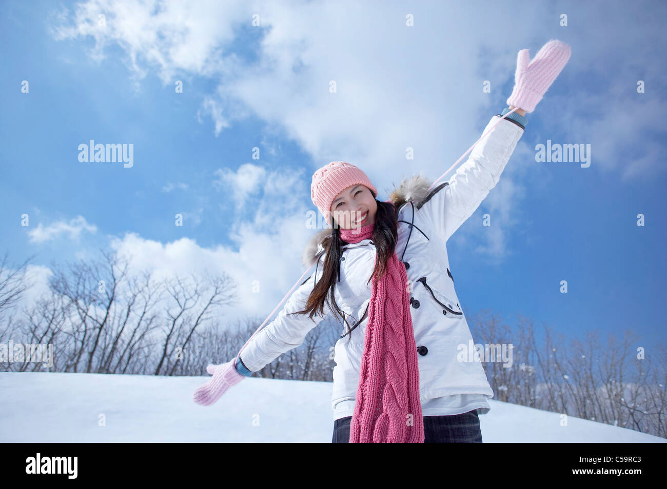 Young woman enjoying snow Stock Photo - Alamy