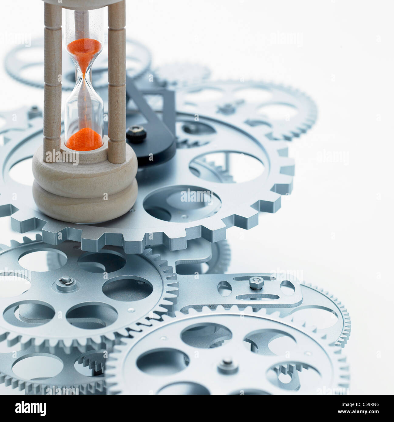 Close-up of hourglass with gears Stock Photo - Alamy