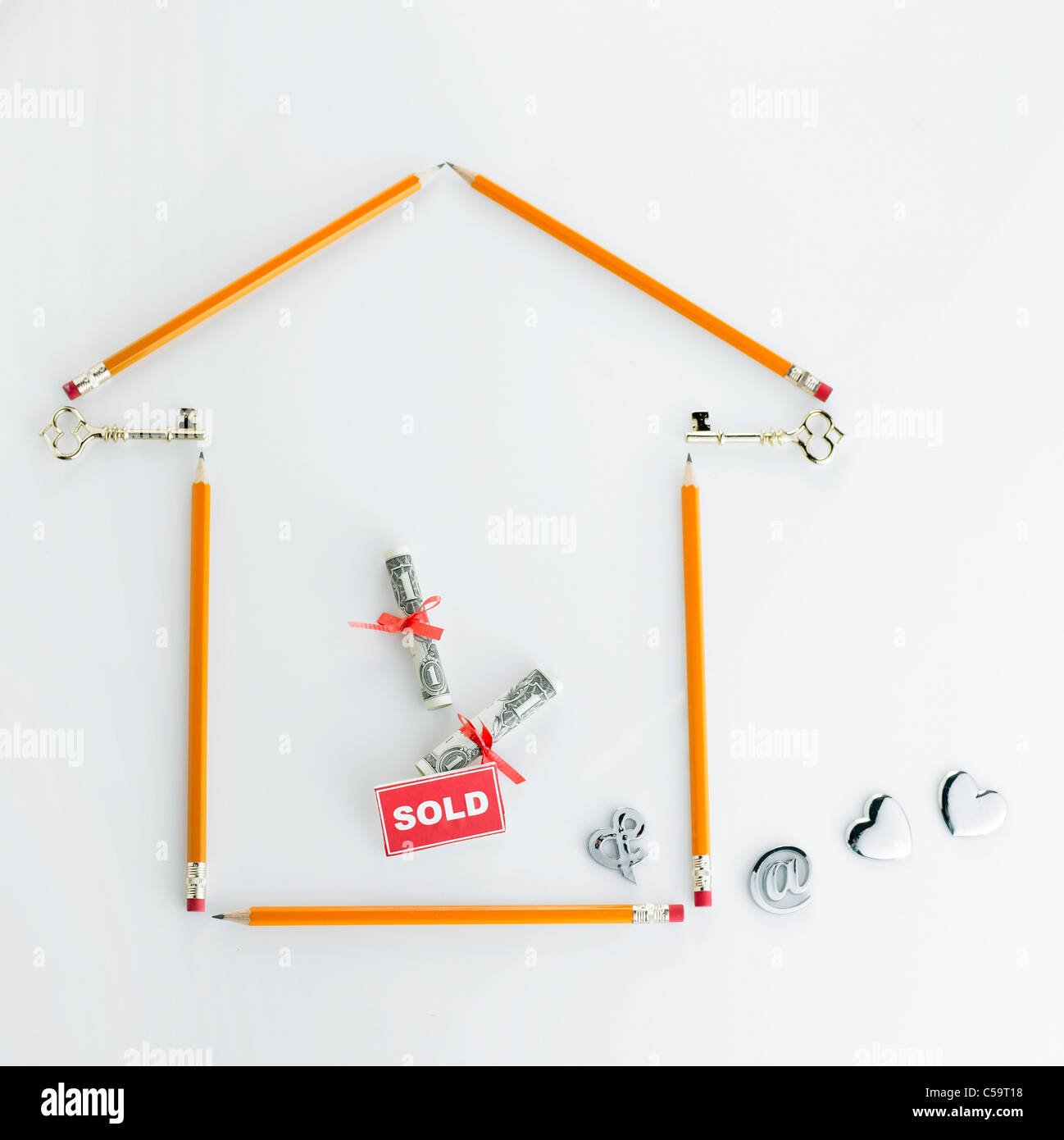 Close-up of House shape created using pencils and Rolled banknote Stock ...