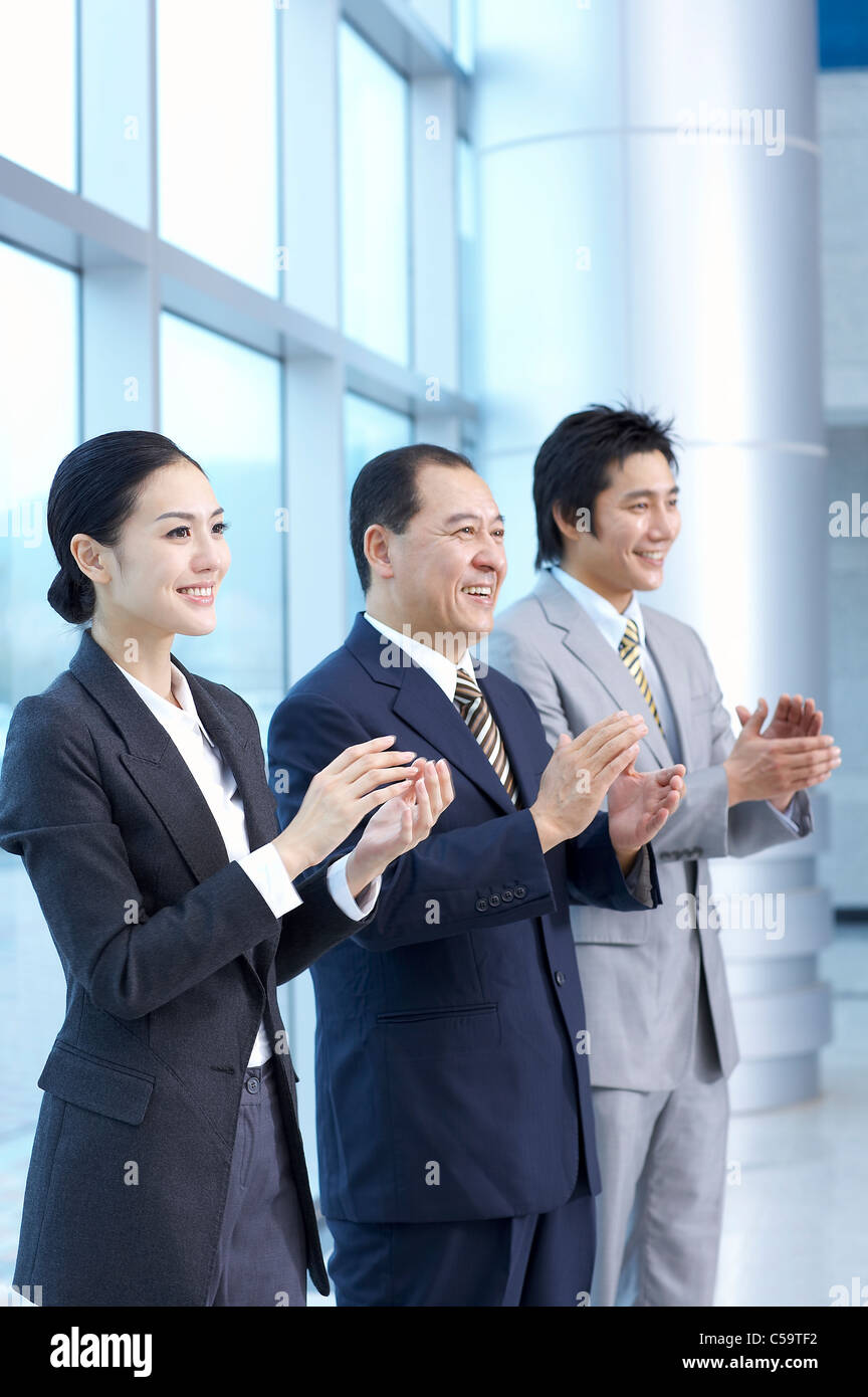 Side view of businesspeople clapping Stock Photo - Alamy