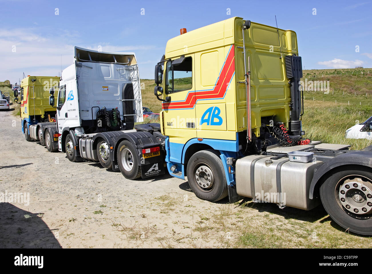 A row of lorries parked on a beach side carpark on the Isle of Anglesey ...