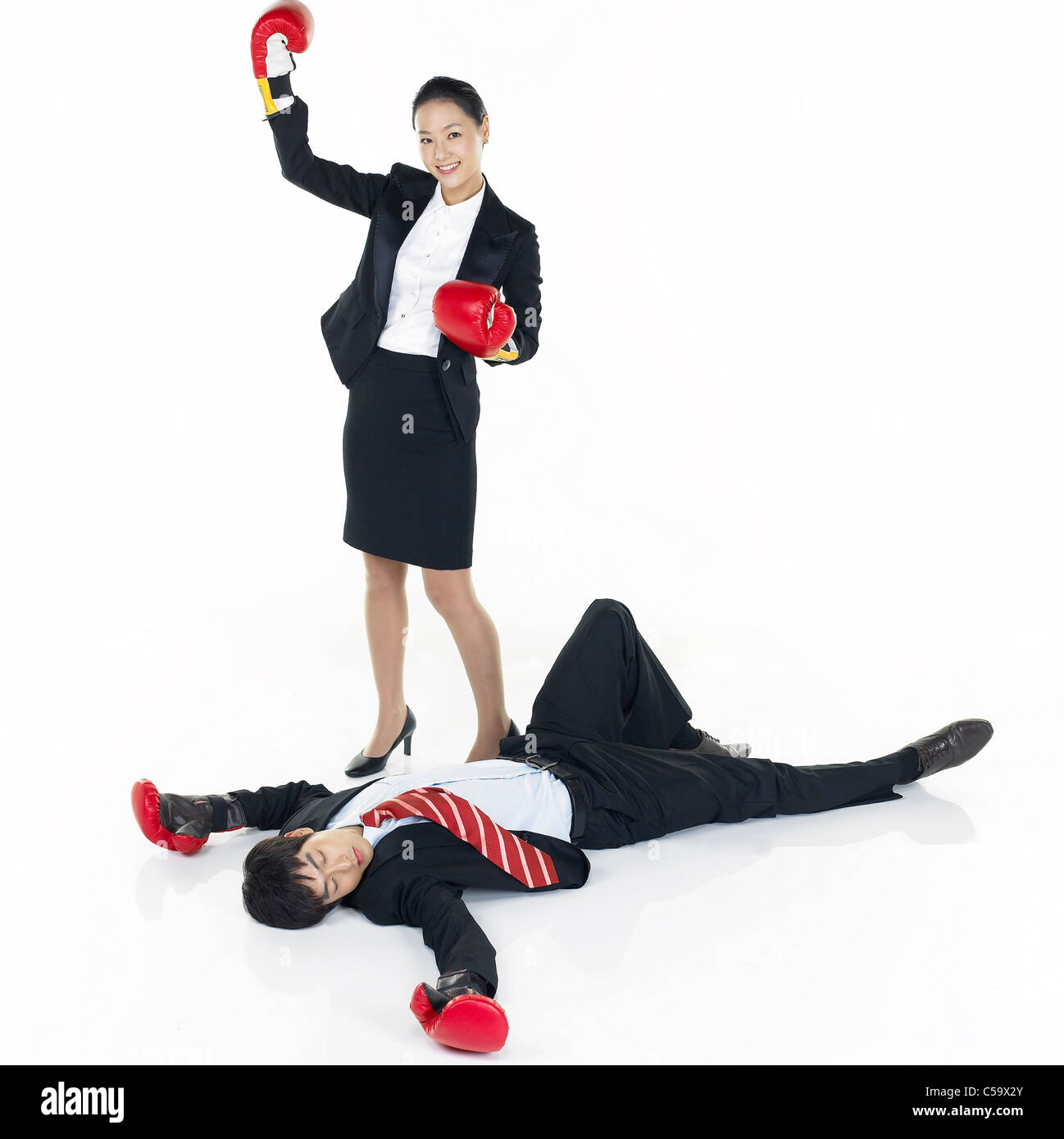 Portrait of businesswoman knocked out businessman Stock Photo - Alamy Portrait of businesswoman knocked out businessman Stock Photo - Alamy