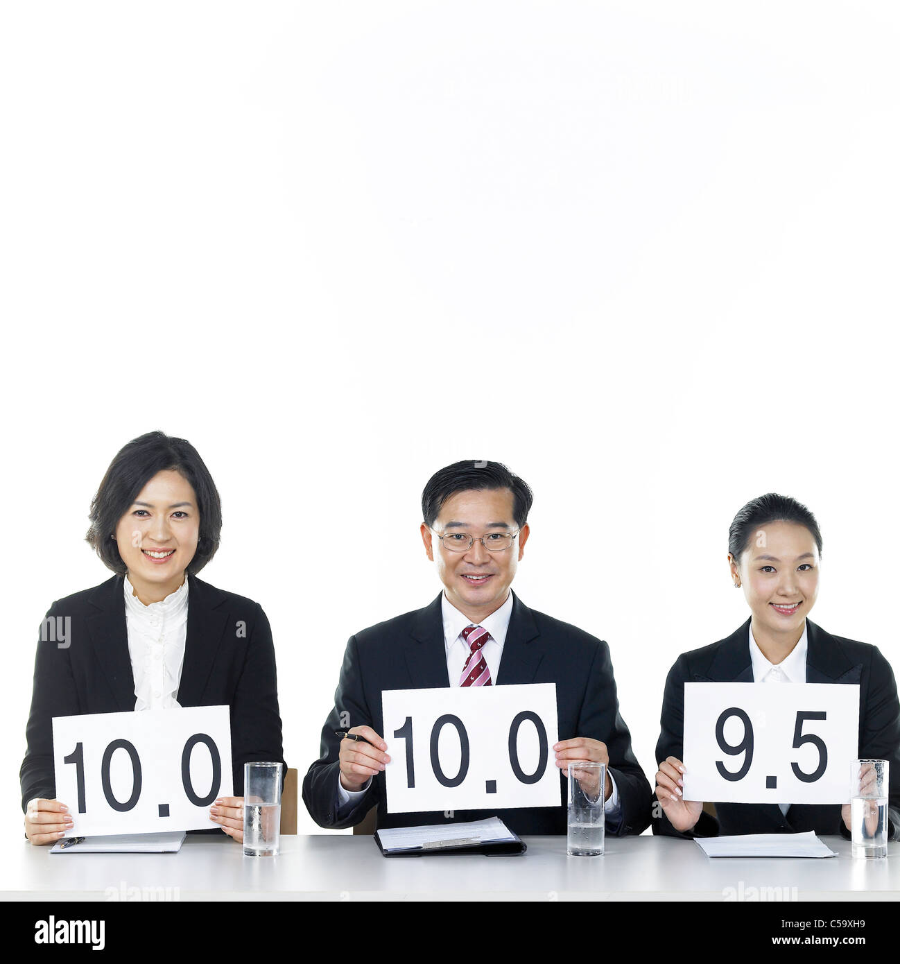 Portrait of businesspeople holding score cards Stock Photo - Alamy
