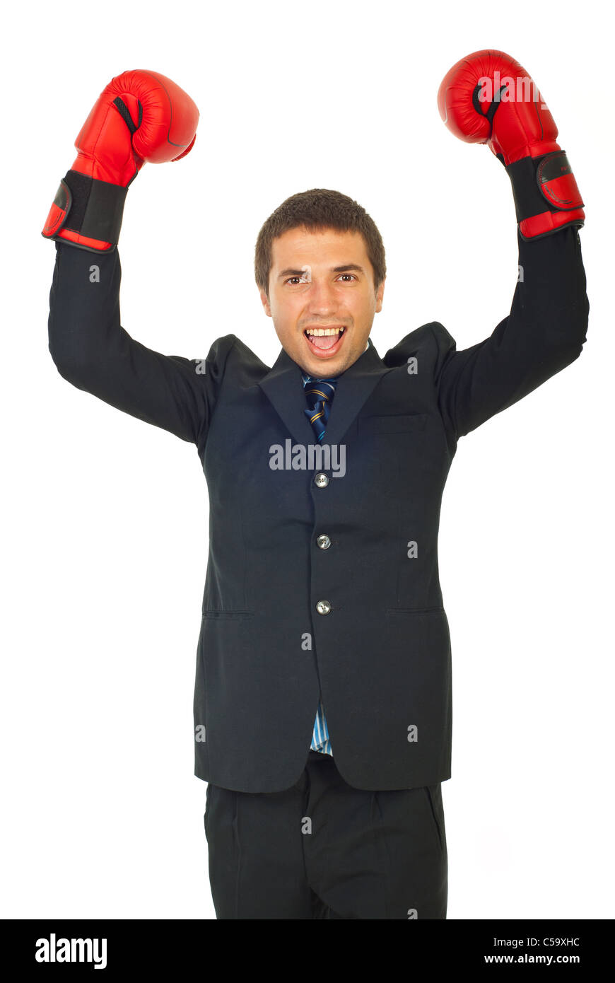 Victorious business man raising hands with boxing gloves and cheering ...