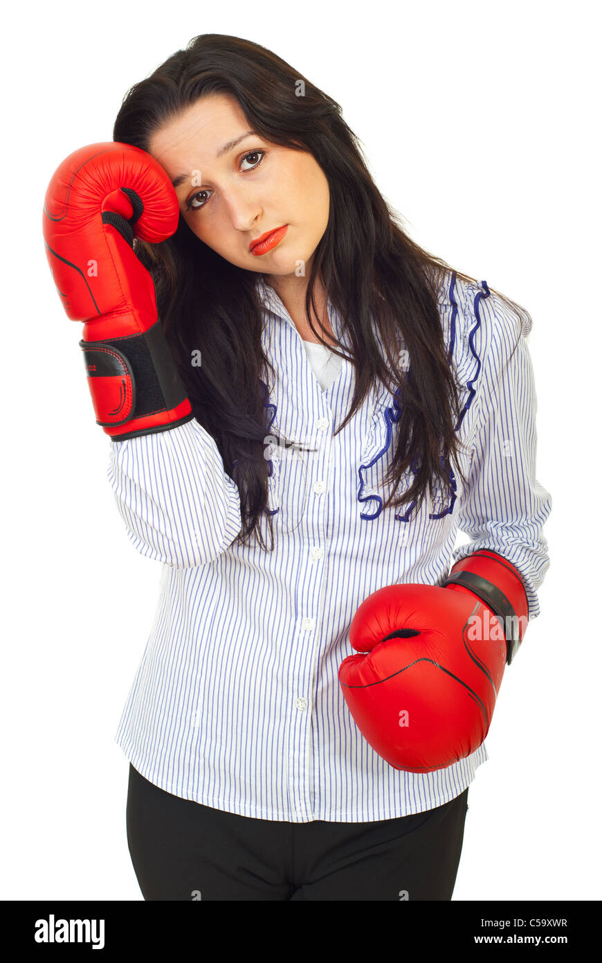 Sad business woman with boxing gloves holding hand to head and thinking ...