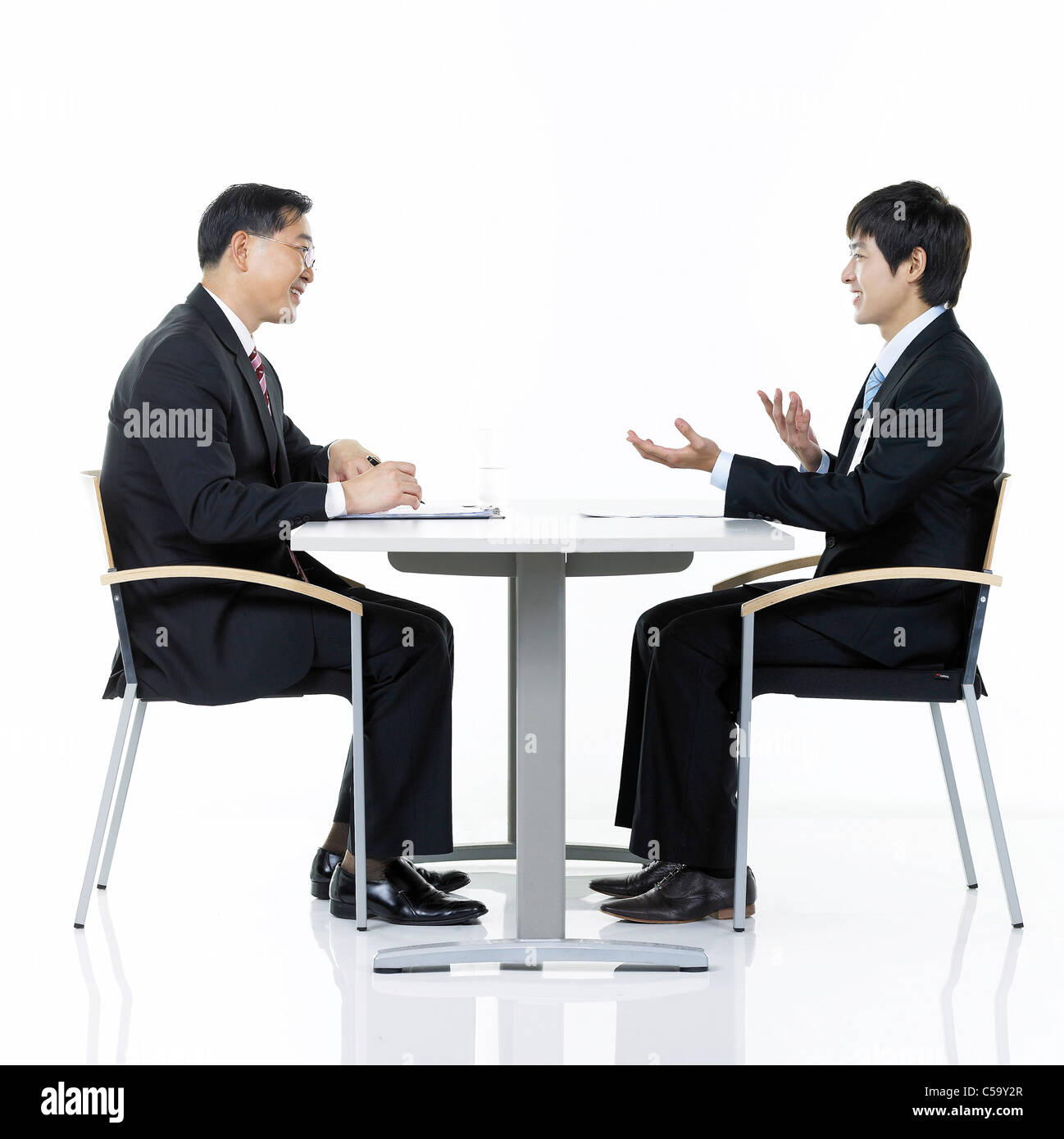 Side view of business people discussing Stock Photo - Alamy