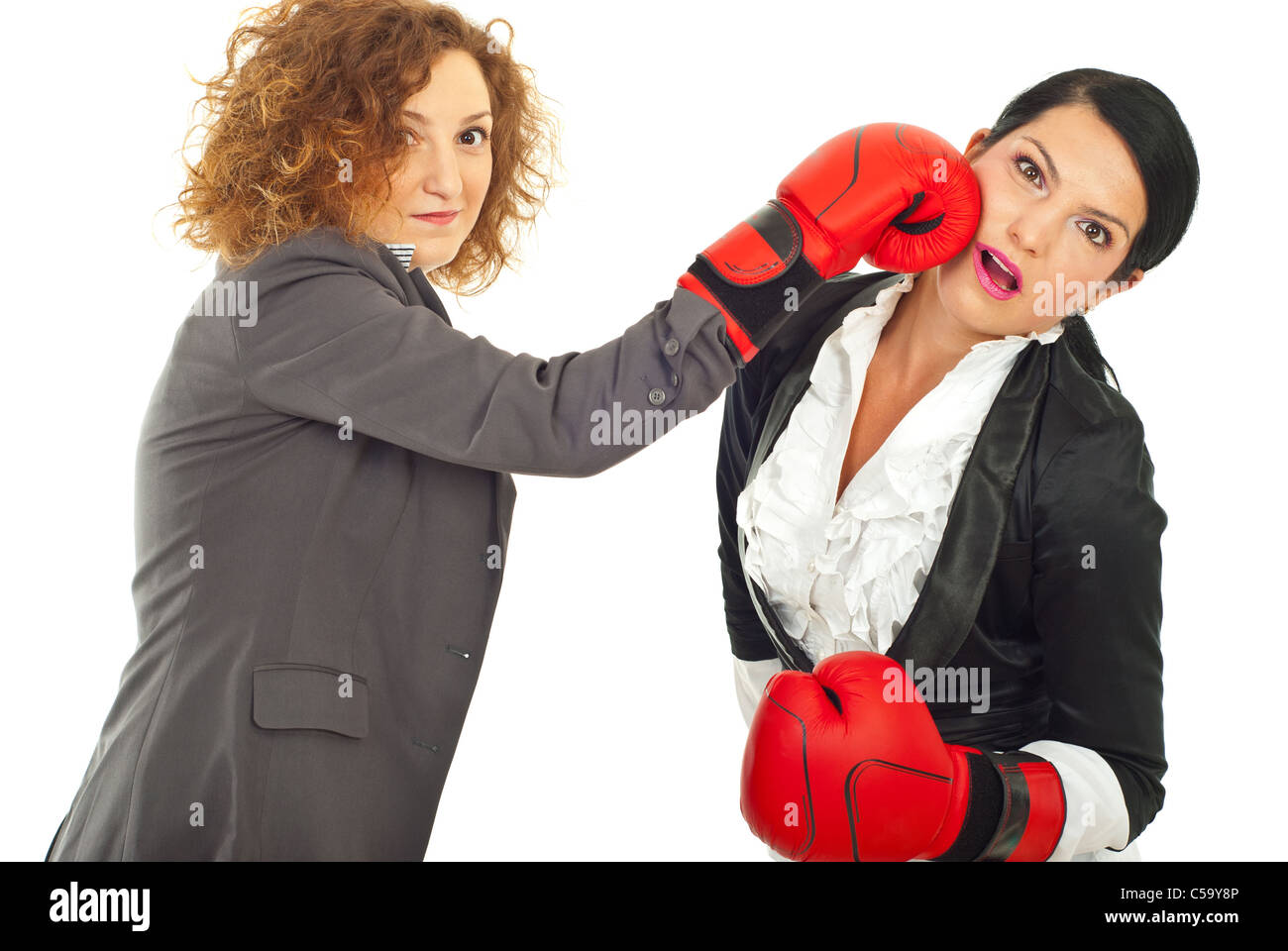 Two business women fight with boxing glove isolated on white background ...