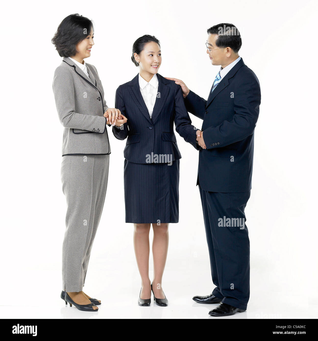 Side view of businesspeople standing Stock Photo - Alamy